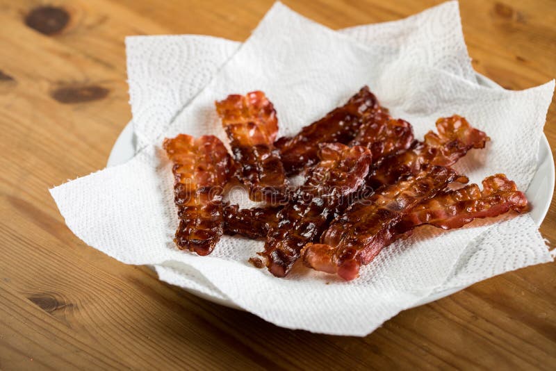 Crispy Fried Bacon Rashers Draining on Plate with Napkin on Wooden ...