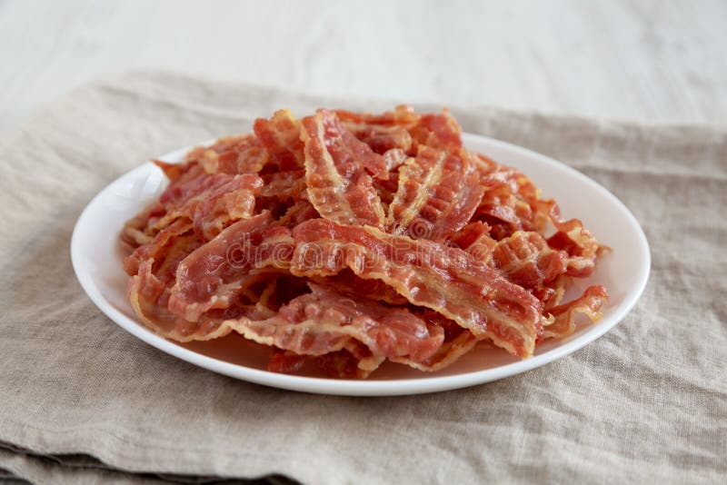 Crispy Fried Bacon on a White Plate, Side View Stock Image - Image of ...