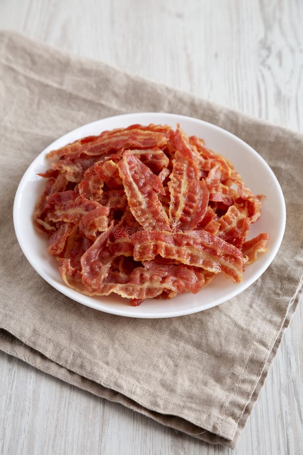 Crispy Fried Bacon on a White Plate, Side View Stock Photo - Image of ...