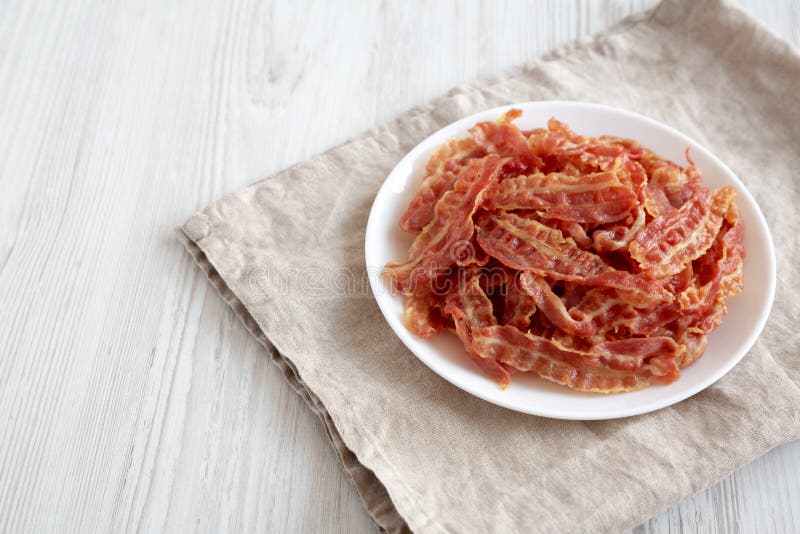 Crispy Fried Bacon on a White Plate, Side View. Copy Space Stock Photo ...