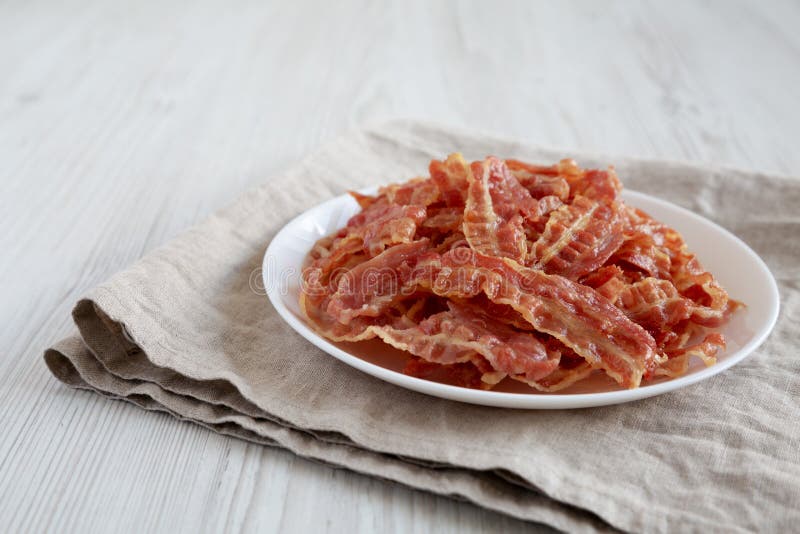 Crispy Fried Bacon on a White Plate, Side View. Space for Text Stock ...