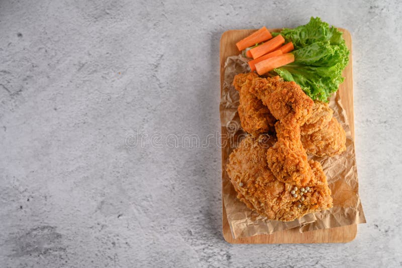 Crispy Fried Chicken on a Cutting Board with Carrot, Top View Stock ...