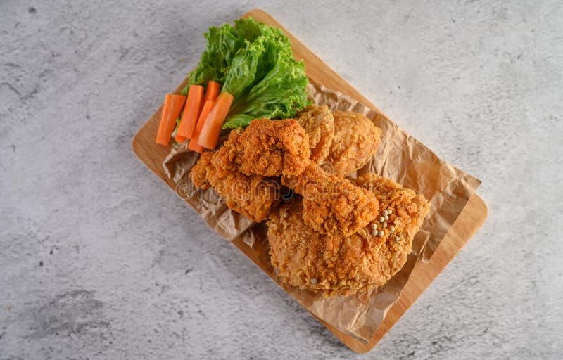 Crispy Fried Chicken on a Cutting Board with Carrot, Top View Stock ...
