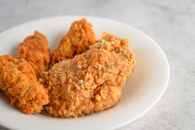 Crispy Fried Chicken Sprinkled with Pepper Seeds on a White Plate ...