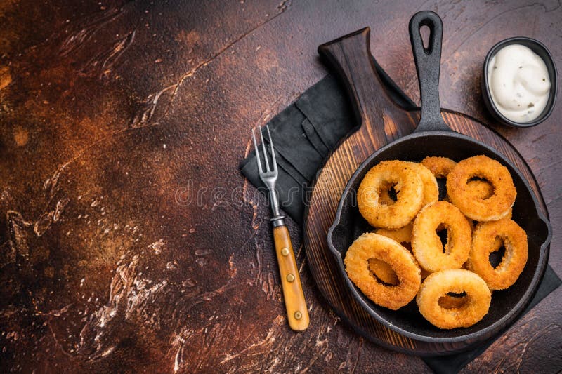 Crispy Fried Onion Rings, Delicious Snack in a Pan. Brown Background ...