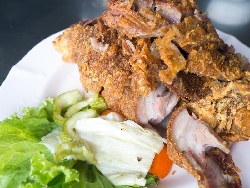 Crispy Fried Pork Leg Placed on a Plate with Vegetables and Seasoning ...