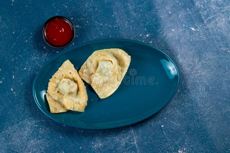 Crispy Fried Wonthon Dim Sum Wraps with Tomato Sauce Served in a Dish ...