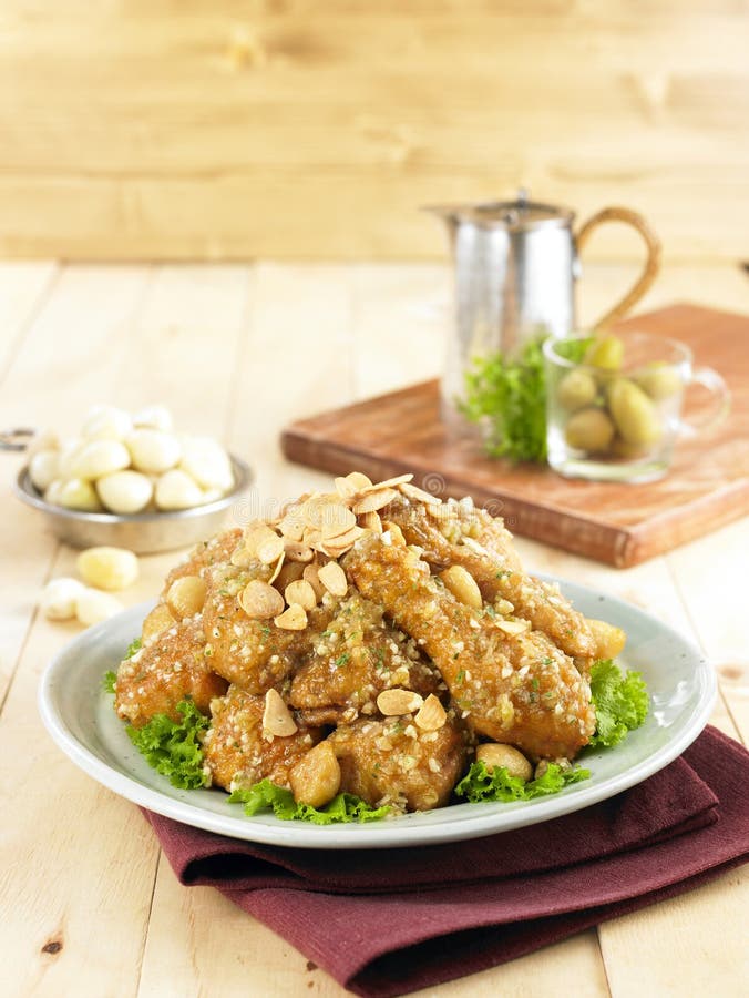 Crispy Garlic Fried Chicken Sunsal on White Plate with Herbs Stock ...