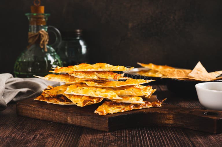 Crispy Lavash Chips with Cheese and Garlic on a Board on the Table ...