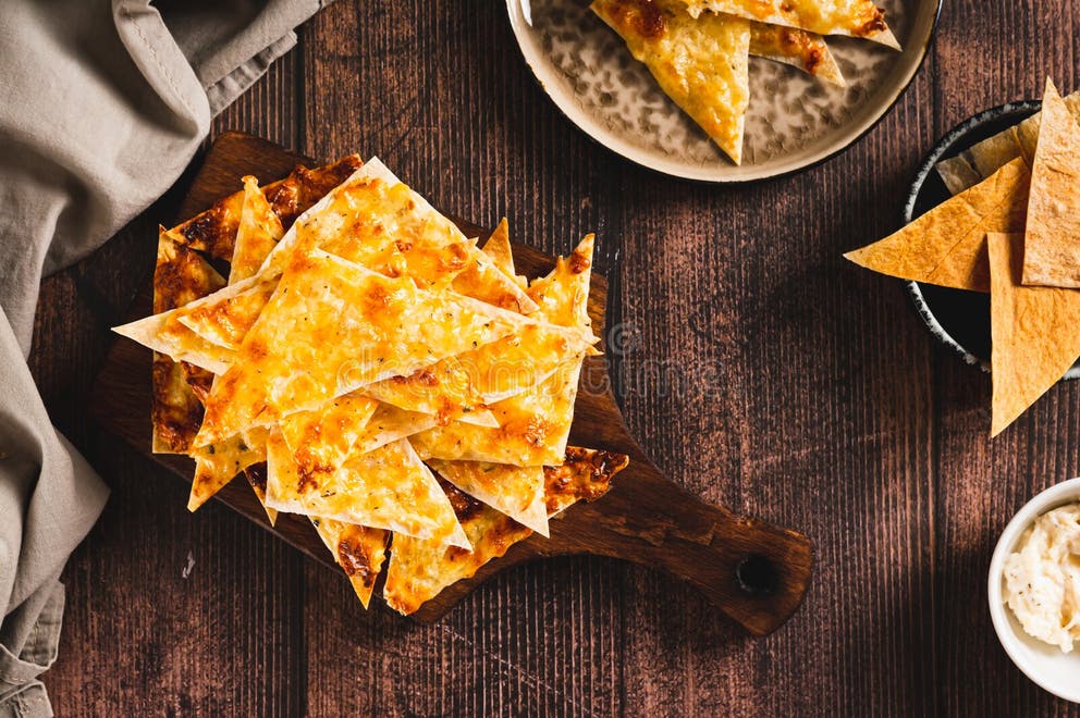 Crispy Lavash Chips with Cheese and Garlic on a Board on the Table Top ...