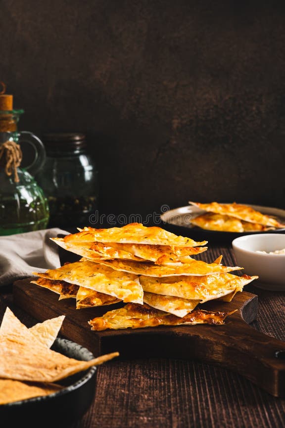Crispy Lavash Chips with Cheese and Garlic on a Board on the Table ...