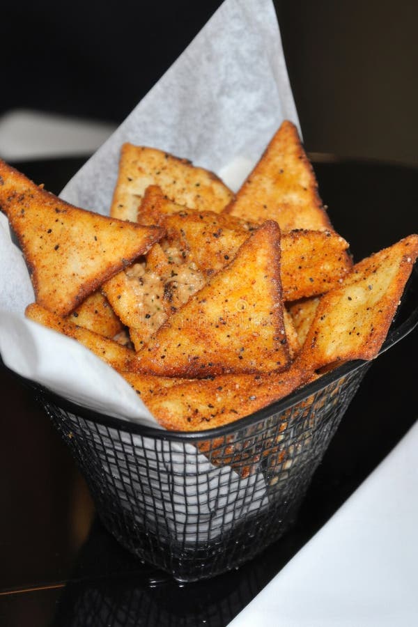 Crispy Pepper-seasoned Tortilla Chips in Black Wire Basket Stock Photo ...