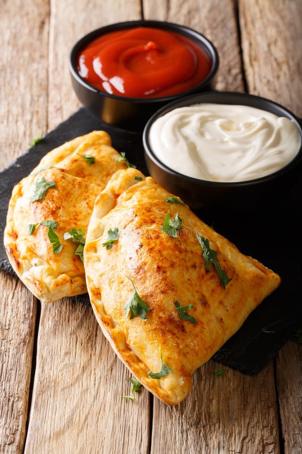 Crispy Pizza Calzone with Meat and Cheese Close-up. Vertical Stock ...