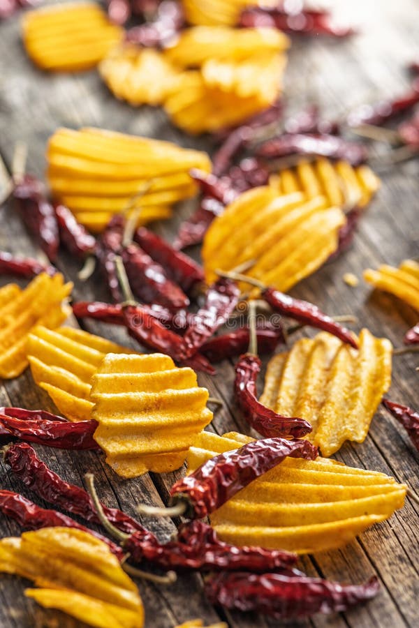 Crispy Potato Chips and Chili Peppers on Wooden Table Stock Photo ...
