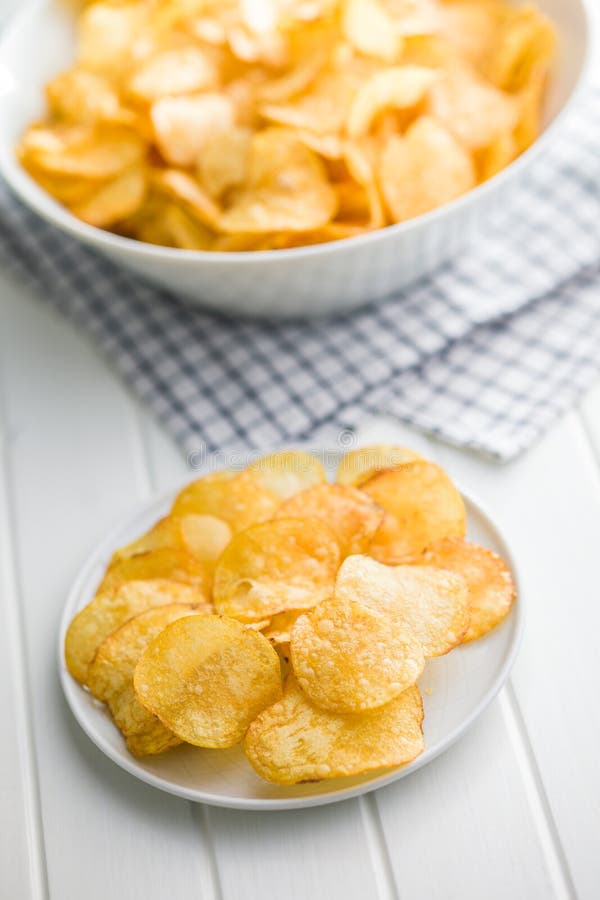 Crispy Potato Chips on Plate on White Table Stock Image - Image of ...