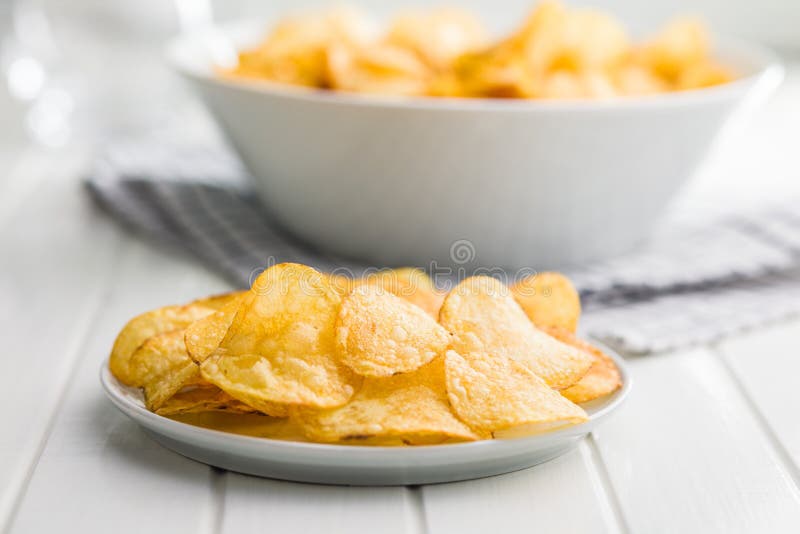 Crispy Potato Chips on Plate on White Table Stock Image - Image of ...