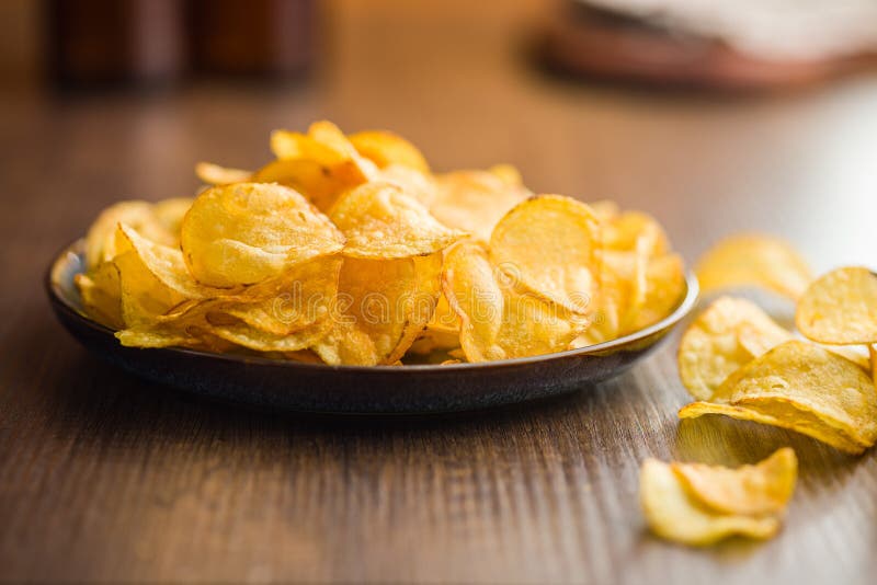 Crispy Potato Chips on Plate on Wooden Table Stock Photo - Image of ...