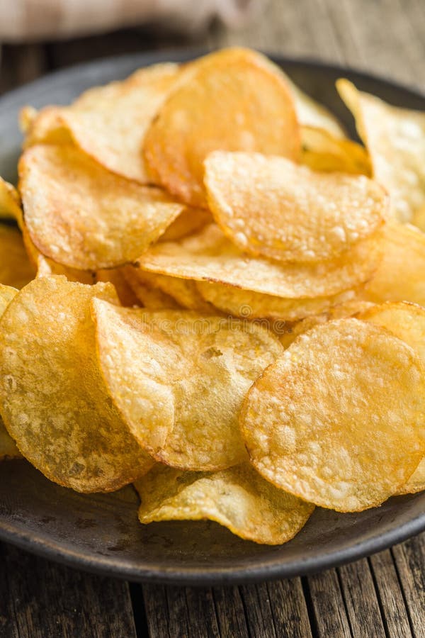 Crispy Potato Chips on Plate on Wooden Table Stock Image - Image of ...