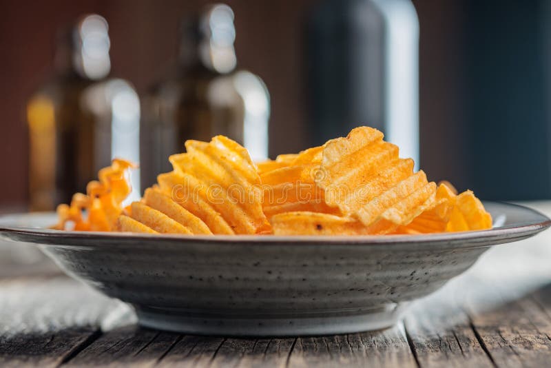 Crispy Potato Chips on Plate on Wooden Table Stock Image - Image of ...