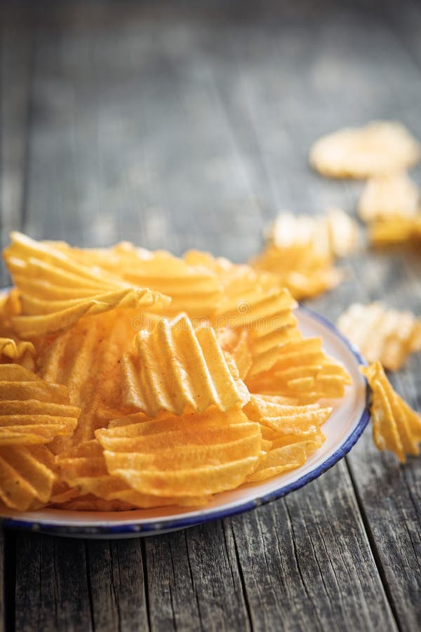 Crispy Potato Chips on Plate on Wooden Table Stock Photo - Image of ...