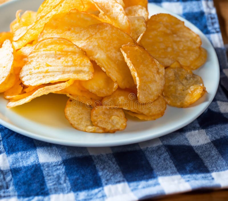 Crispy Potato Chips in a White Plate on an Old Kitchen Table Generative ...