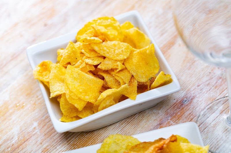 Crispy Potato Chips in Paper Bag with Colorful Seasoning Flying Against ...