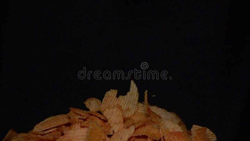 Crispy Potato Corrugated Chips Falling Against Black Background Stock ...