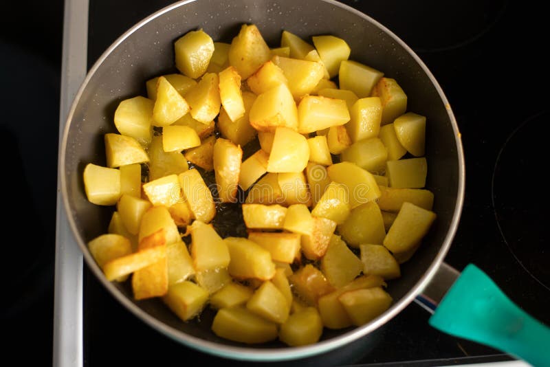 Crispy Potato Cubes Frying in a Pan on the Stovetop Stock Image - Image ...