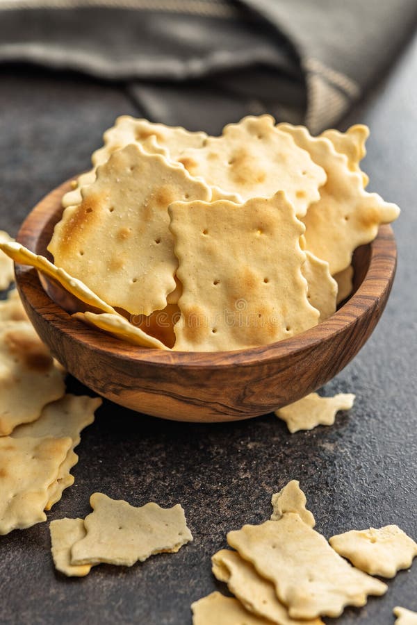 A Crispy Salted Crackers in Bowl on Black Table Stock Image - Image of ...