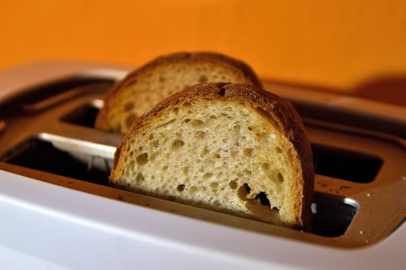 Crispy Slices of Bread in a Toaster Stock Photo - Image of closeup ...