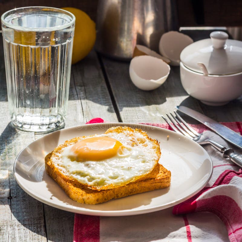 Crispy Toast with a Fried Egg and a Glass of Water, Lemon, Break Stock ...
