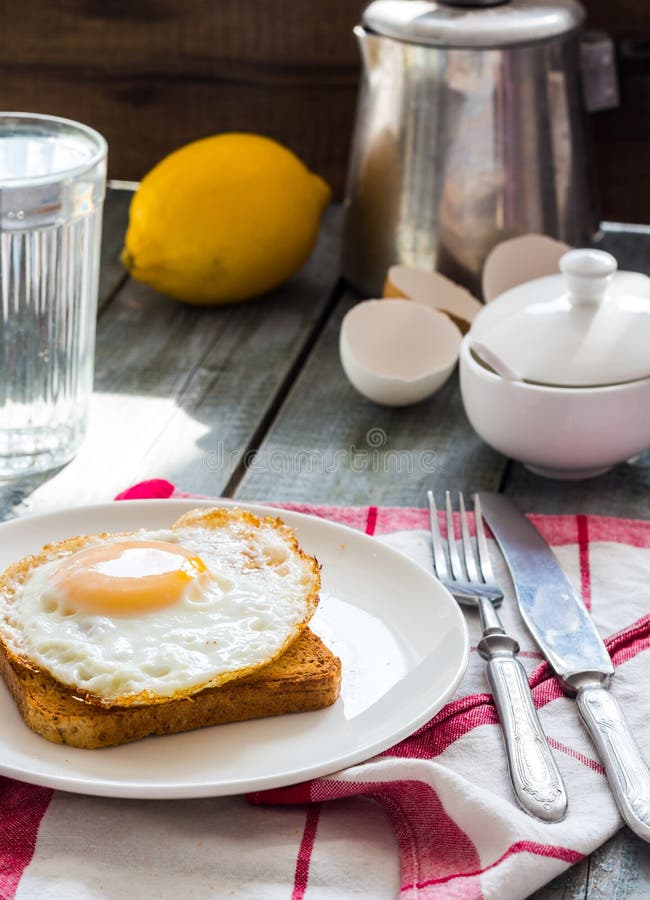 Crispy Toast with a Fried Egg and a Glass of Water, Lemon, Break Stock ...