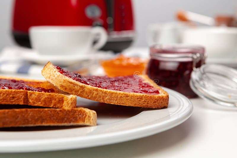 Crispy Toasts Covered with Fruit Jam Served on Kitchen Table Stock ...