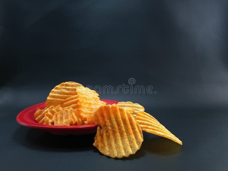 Crispy Wavy Potato Chips Snack Served on a Red Plate Stock Image ...