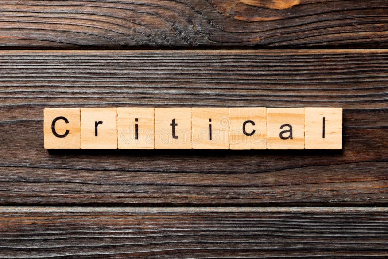 Critical Word Written on Wood Block. Critical Text on Table, Concept ...
