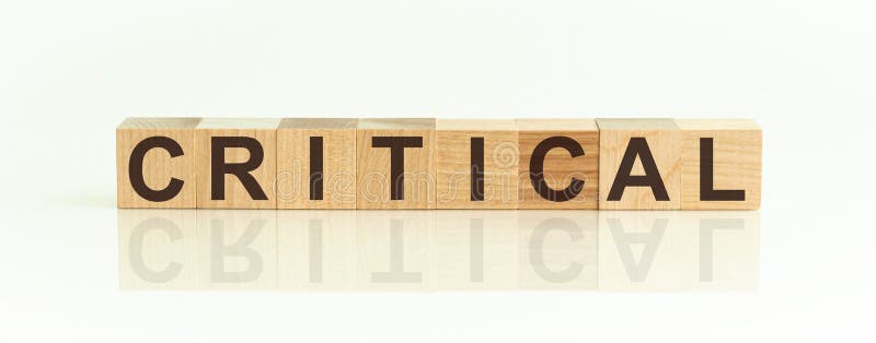 Critical Word Written on Wood Block. Critical Text on Table, Concept ...