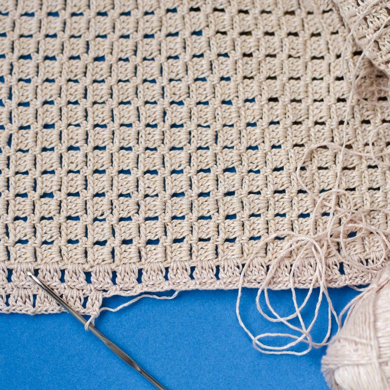 Crochet with Beige Cotton Threads on a Blue Background Stock Image ...