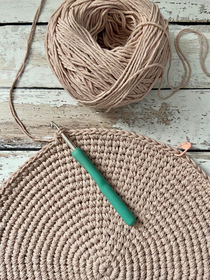 Crochet Circle Table Runner on a Wooden Table with a Crochet Hook and ...