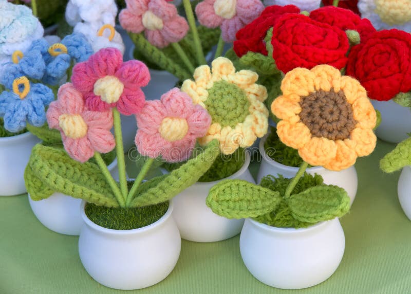 Crochet Flowers in Small White Plastic Pots on a Green Table Stock ...