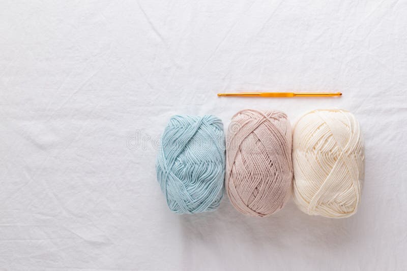 Crochet Hook and Balls of Cotton Yarn Pastel Colors on a White Table ...