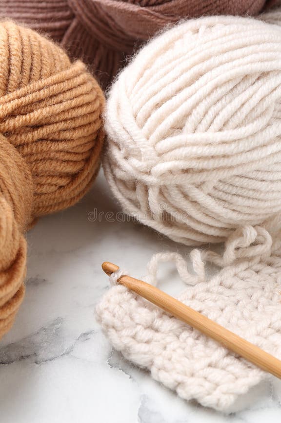 Crochet Hook, Pattern Samples and Colorful Yarns on White Marble Table ...