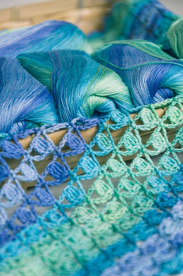 Crocheting in Blue and Green Tones and Skeins Piled Together Stock ...