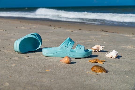Crocs Shoes on the Sand by the Ocean with Shells and Starfish Editorial ...