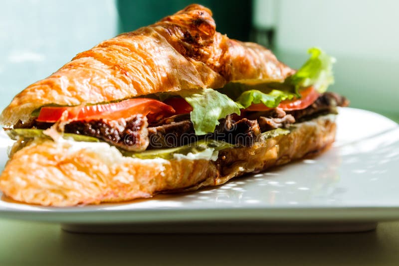 Croissant with Beef and Fresh Vegetables Illuminated by Sunlight. Stock ...