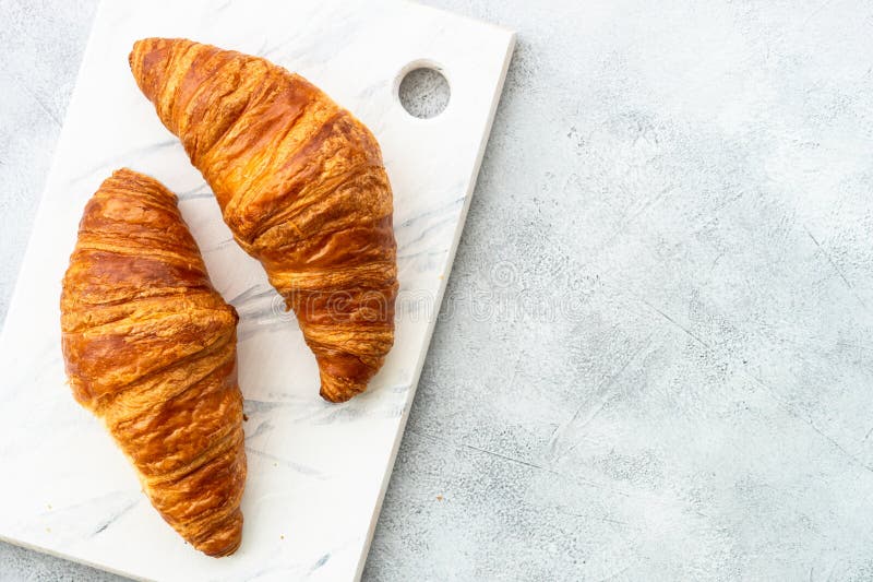 Croissant on Cutting Board at White Table Top View. Stock Photo - Image ...