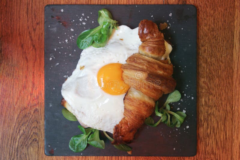 A croissant with fried egg stock photo. Image of continental - 141252582