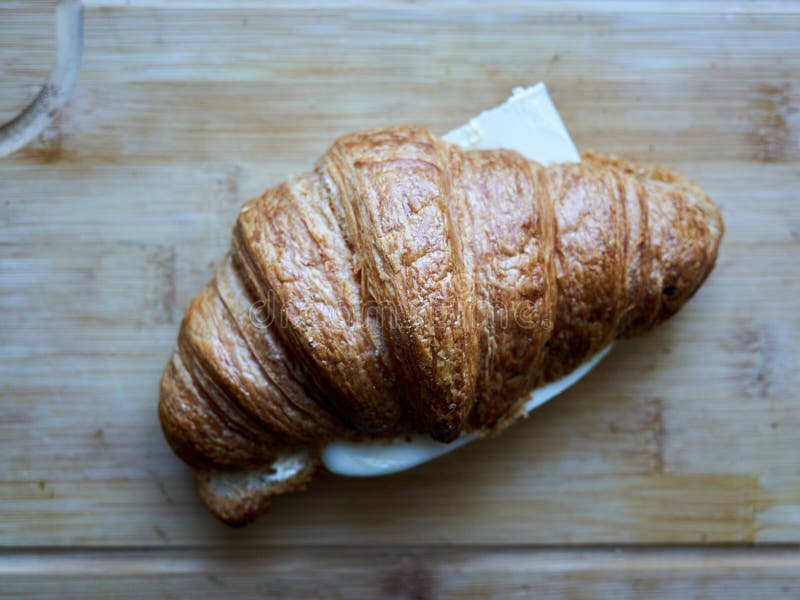 Croissant with a Slice of Cheese on Top Stock Photo - Image of plate ...