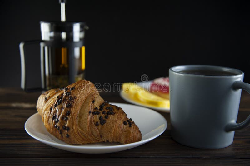 Croissant with Tea on the Table Stock Image - Image of bake, lighting ...
