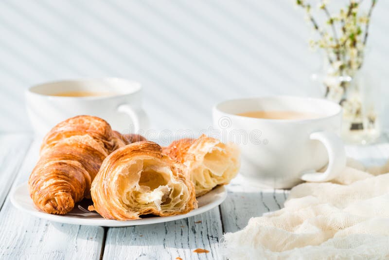 Croissants with Cups of Herbal Tea on White Rustic Table Stock Photo ...