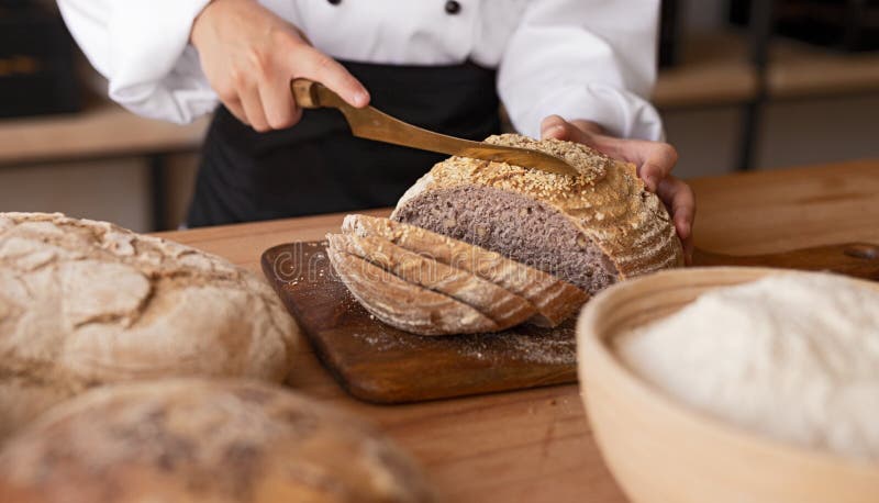 Crop baker cutting bread stock image. Image of rustic - 165044883